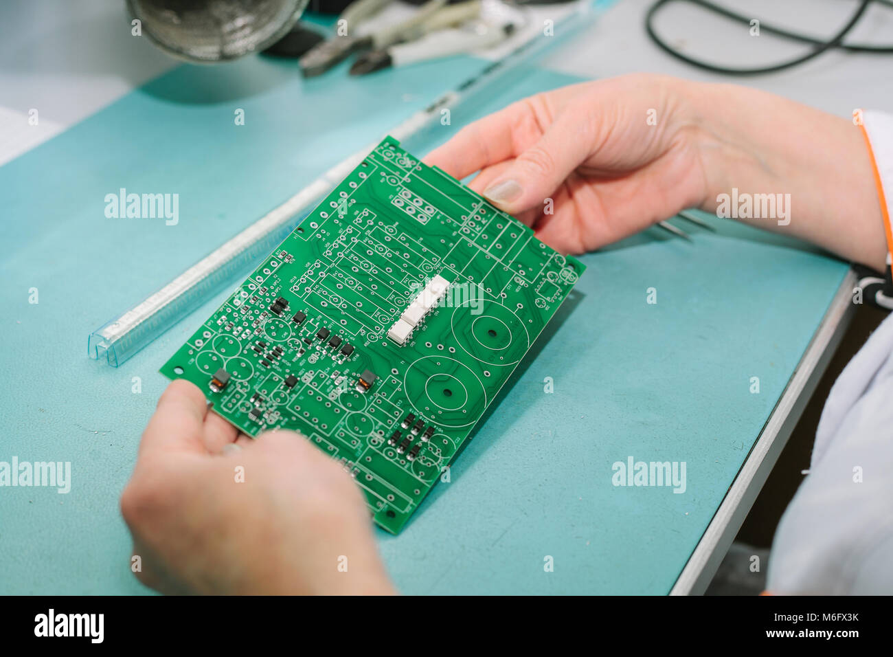 Female computer expert professional technician examining board computer ...