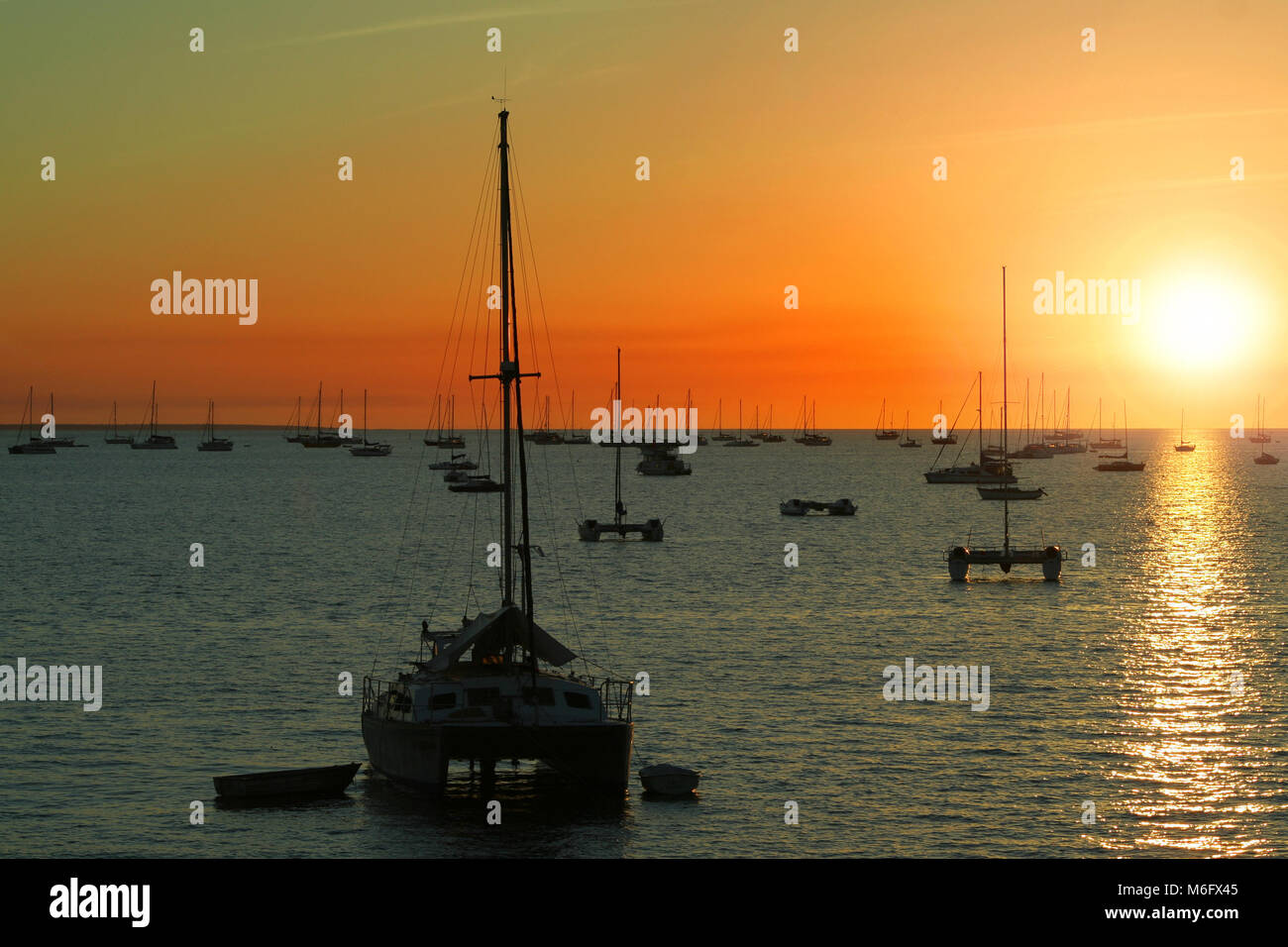 Yachts in a bay at sunset Stock Photo - Alamy