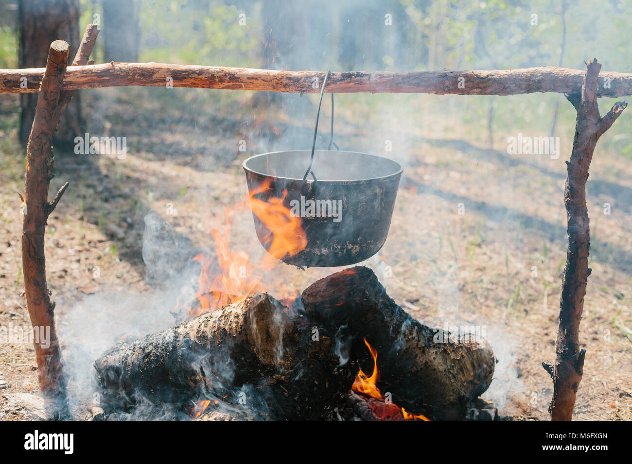 The fire near the camp. Cooking food on a fire. Journey Stock Photo - Alamy