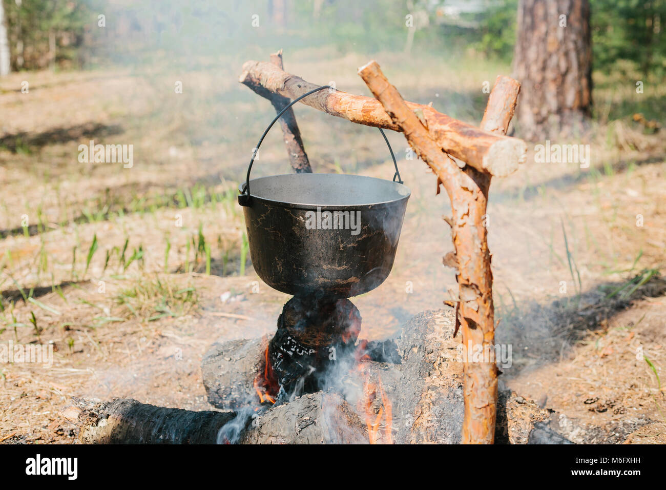 The fire near the camp. Cooking food on a fire. Journey into the wild concept Stock Photo - Alamy