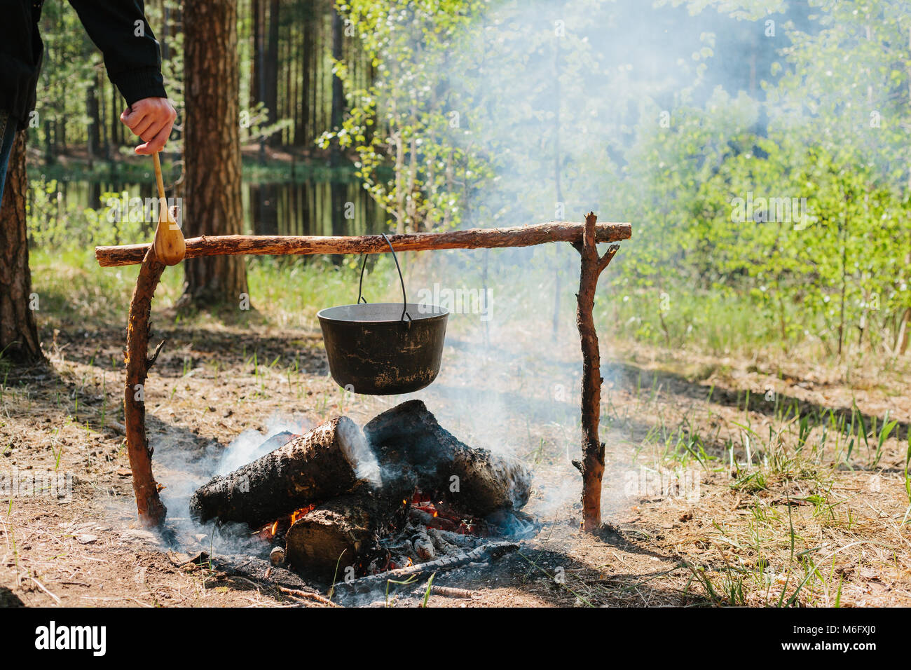 The fire near the camp. Cooking food on a fire. Journey into the wild ...