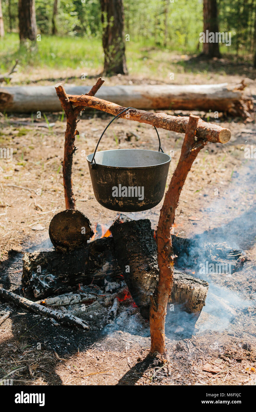 The fire near the camp. Cooking food on a fire. Journey Stock Photo - Alamy