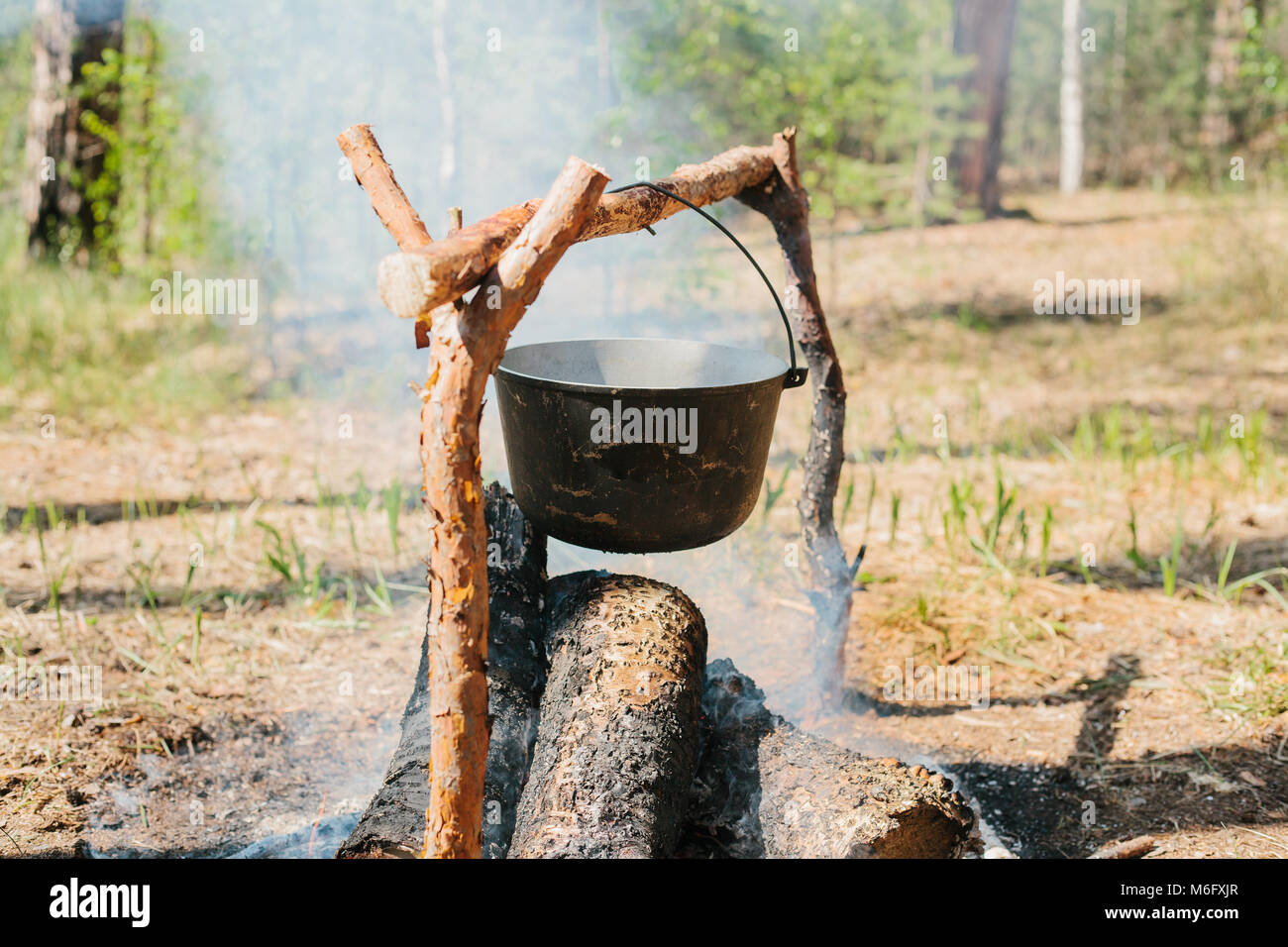 The fire near the camp. Cooking food on a fire. Journey Stock Photo - Alamy