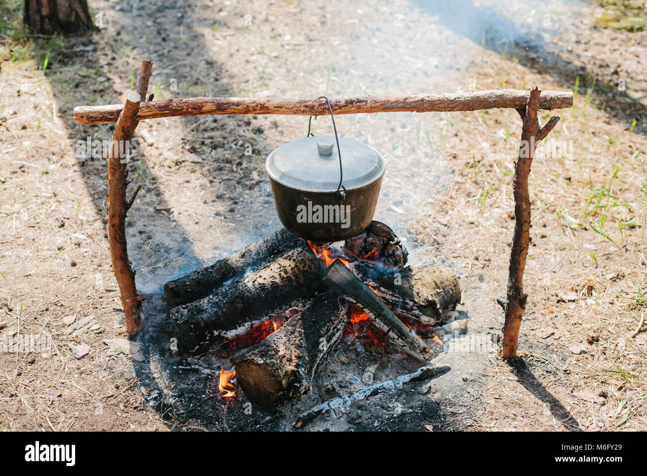 The fire near the camp. Cooking food on a fire. Journey Stock Photo - Alamy
