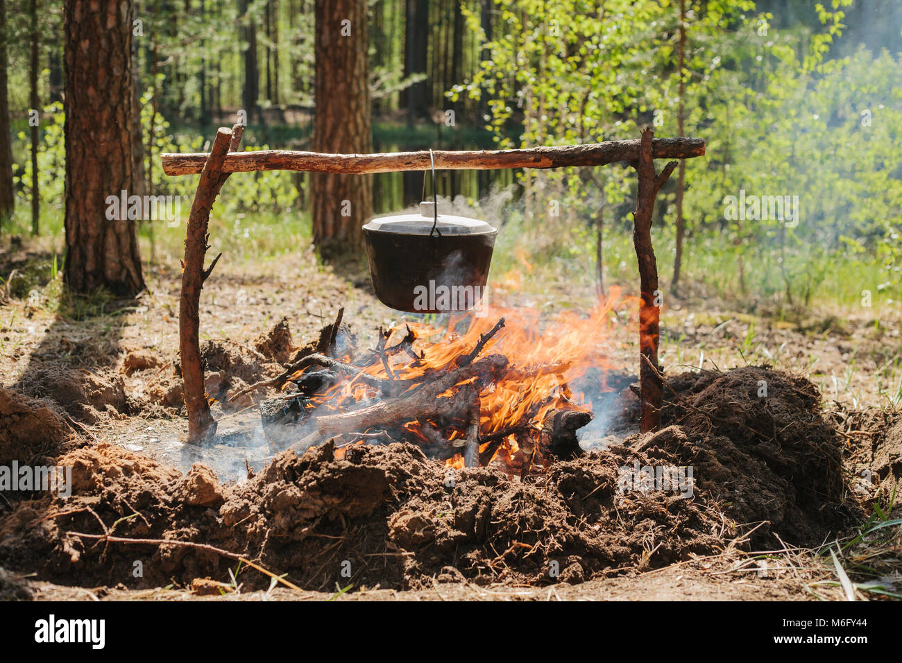 The fire near the camp. Cooking food on a fire. Journey into the wild ...