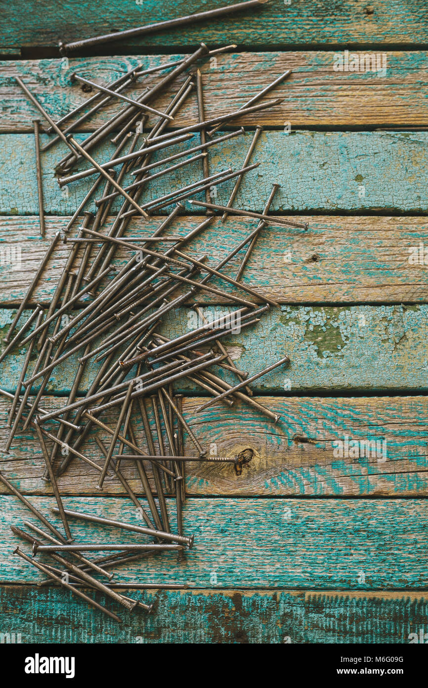 Nails on a wooden surface. Joinery tradition Stock Photo - Alamy