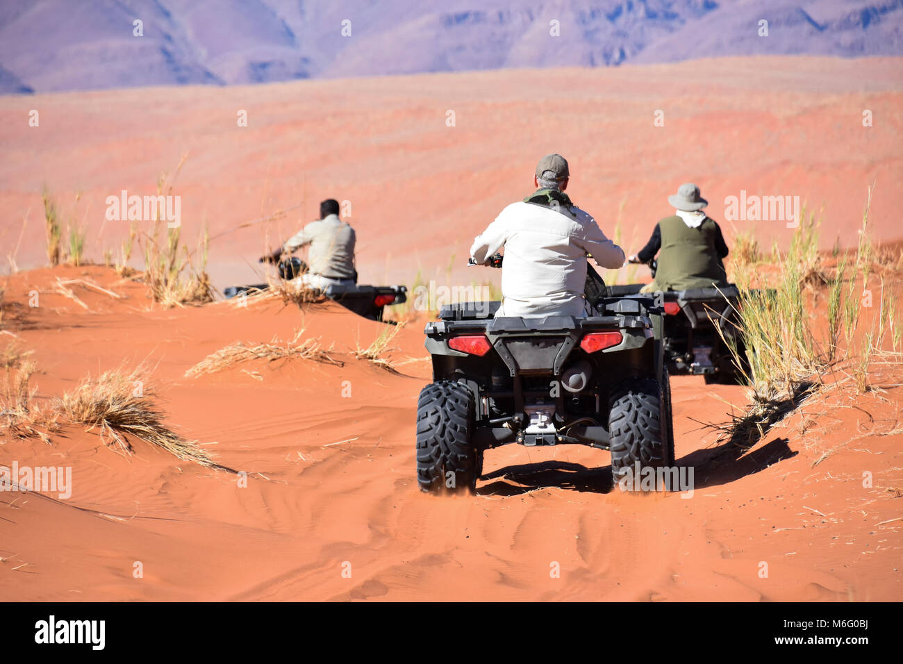 Tourists quad biking in the sossusvlei desert in Namibia Southern ...