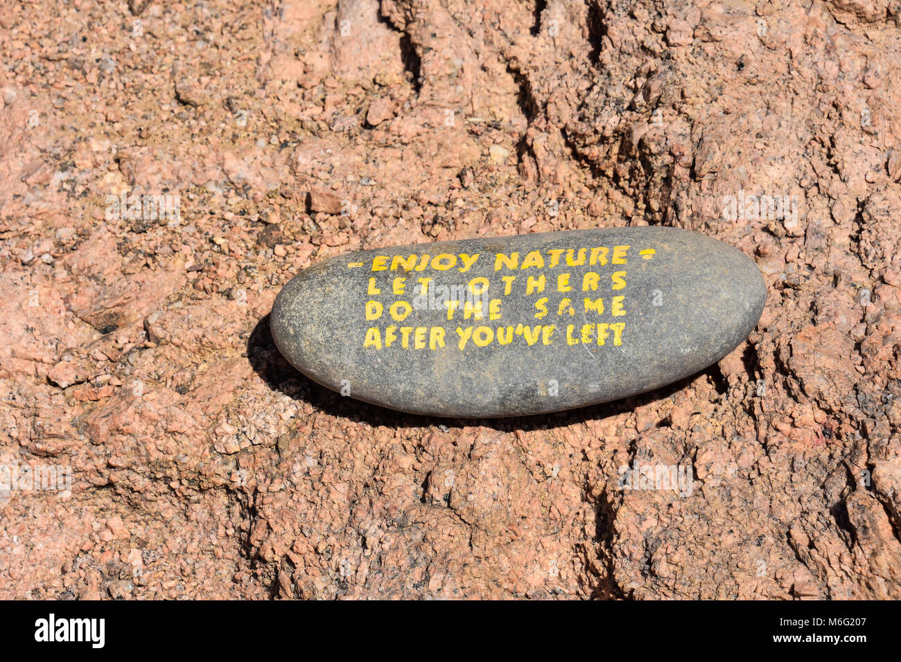 A stone sign saying enjoy nature let others do the same after you have ...
