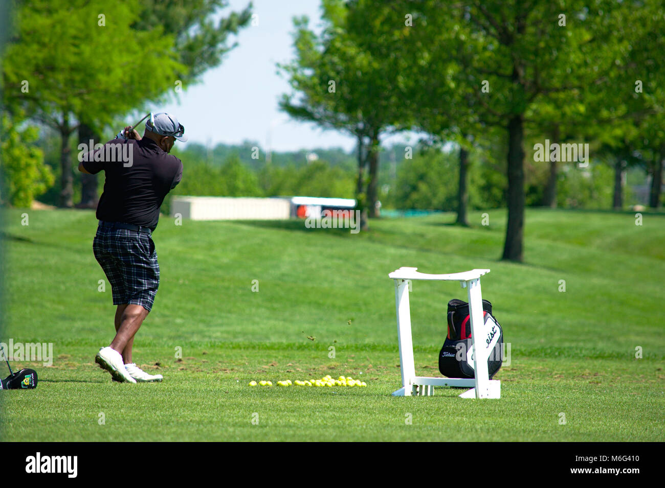 golfers on the range practicing before their round Stock Photo - Alamy