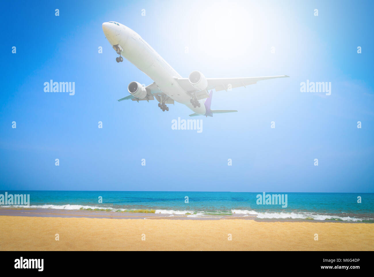 Plane flying on blue sky with cloud background over beach and tropical ...