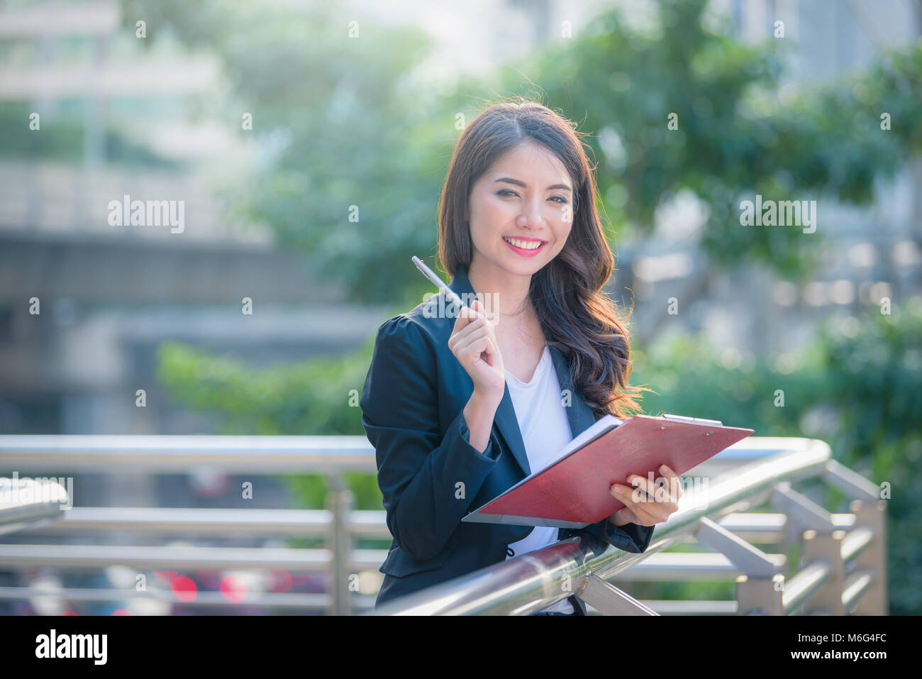 Portrait of business woman happy smile holding check list on clipboard ...