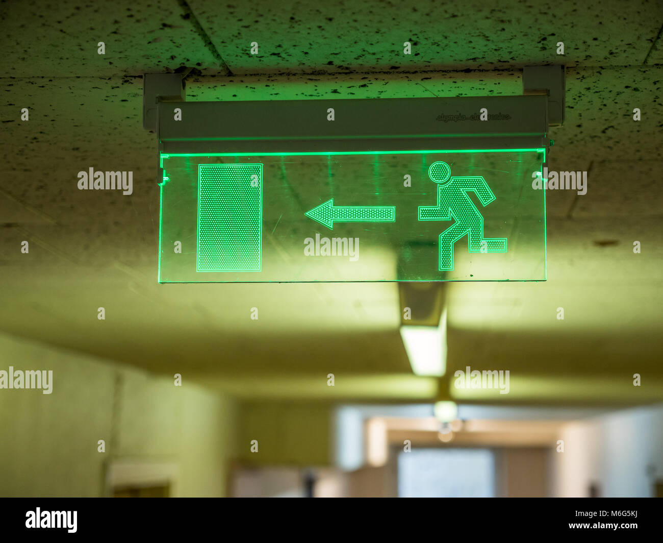 Indoor view green emergency fire exit sign on ceiling Stock Photo - Alamy