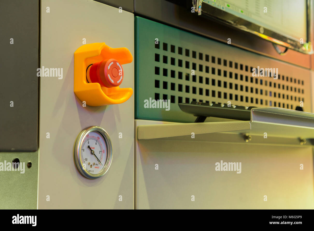 Emergency stop button and vacuum gage in machine Stock Photo - Alamy
