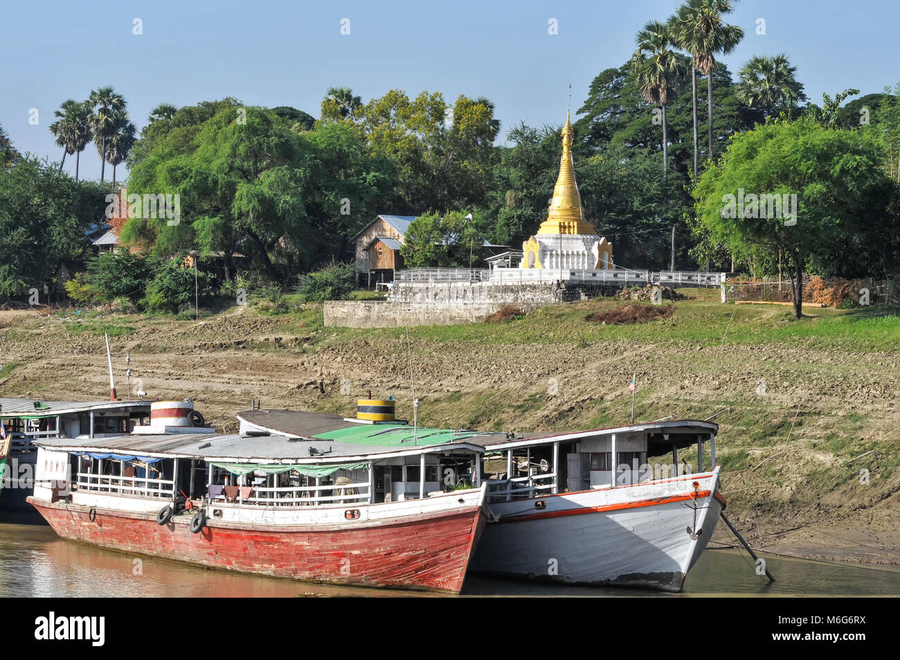 A view of the Irrawaddy River in Myanmar Burma with moored boats and a ...