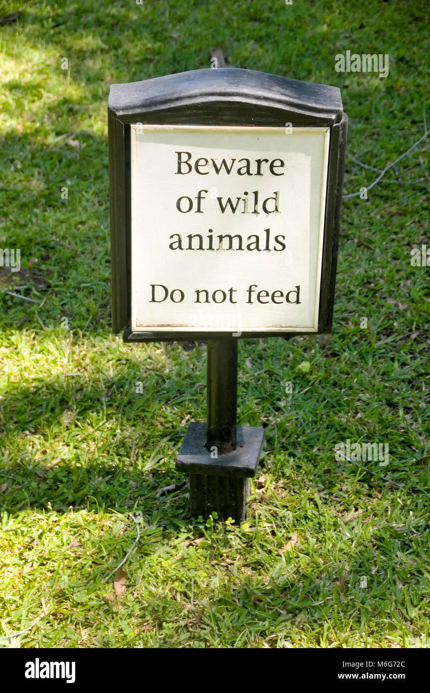 A sign saying be aware of wild animals do not feed Stock Photo - Alamy