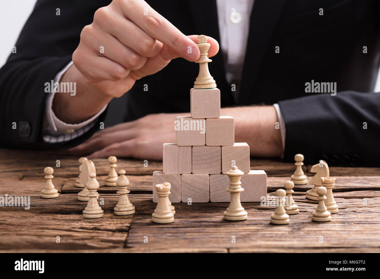 Close-up Of A Businessperson's Hand Placing King Chess Piece On Top Of ...