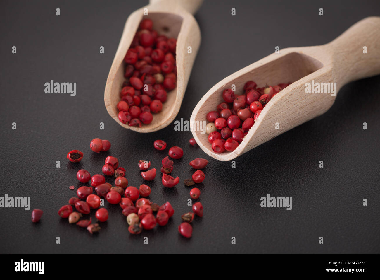 Brazilian pepper on the dark stone Stock Photo - Alamy