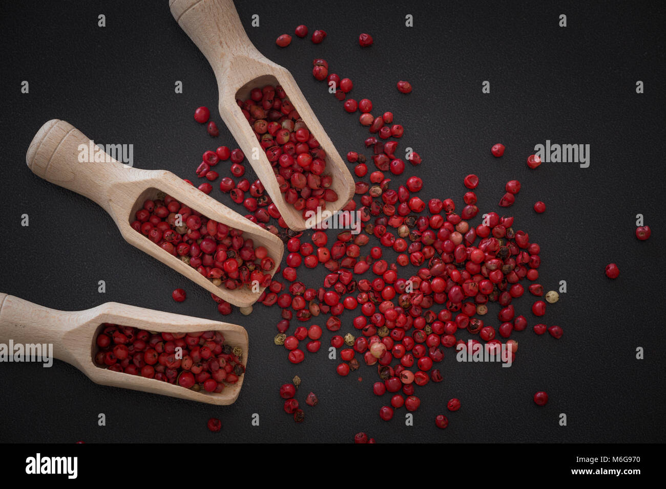 Brazilian pepper on the dark stone Stock Photo - Alamy