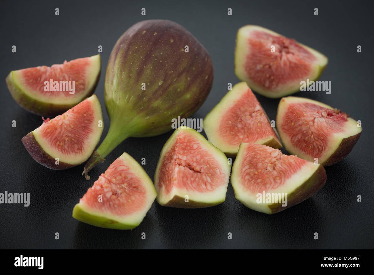 Delicious ripe figs on the dark stone background Stock Photo - Alamy