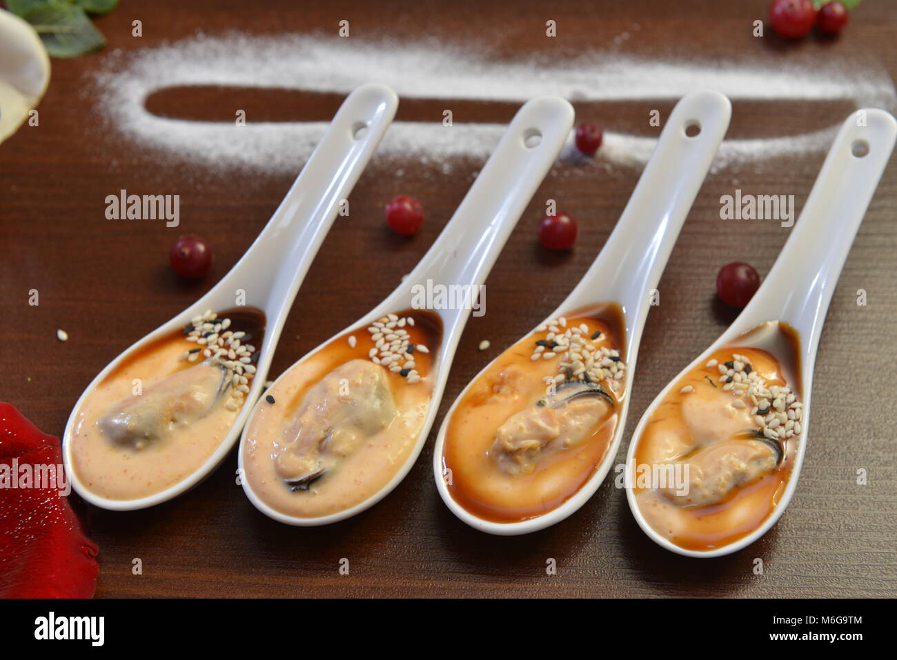 party appetizers. Four white spoons with mussels Spanish Tapas ...