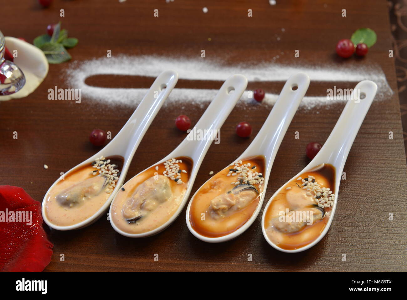 party appetizers. Four white spoons with mussels Spanish Tapas ...