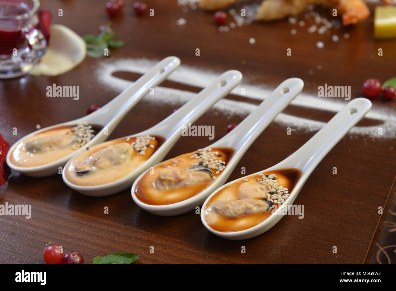 party appetizers. Four white spoons with mussels Spanish Tapas ...