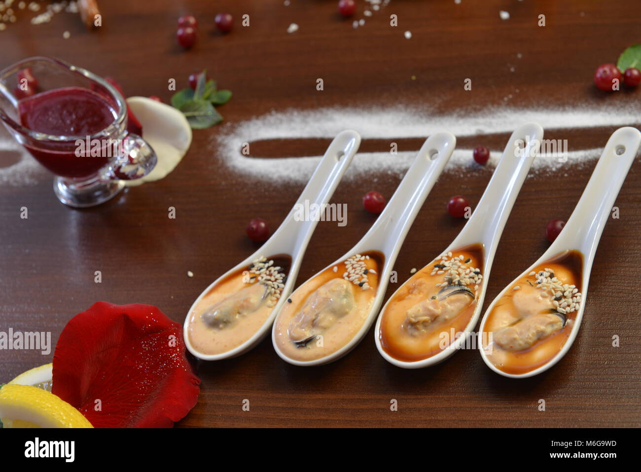 party appetizers. Four white spoons with mussels Spanish Tapas ...