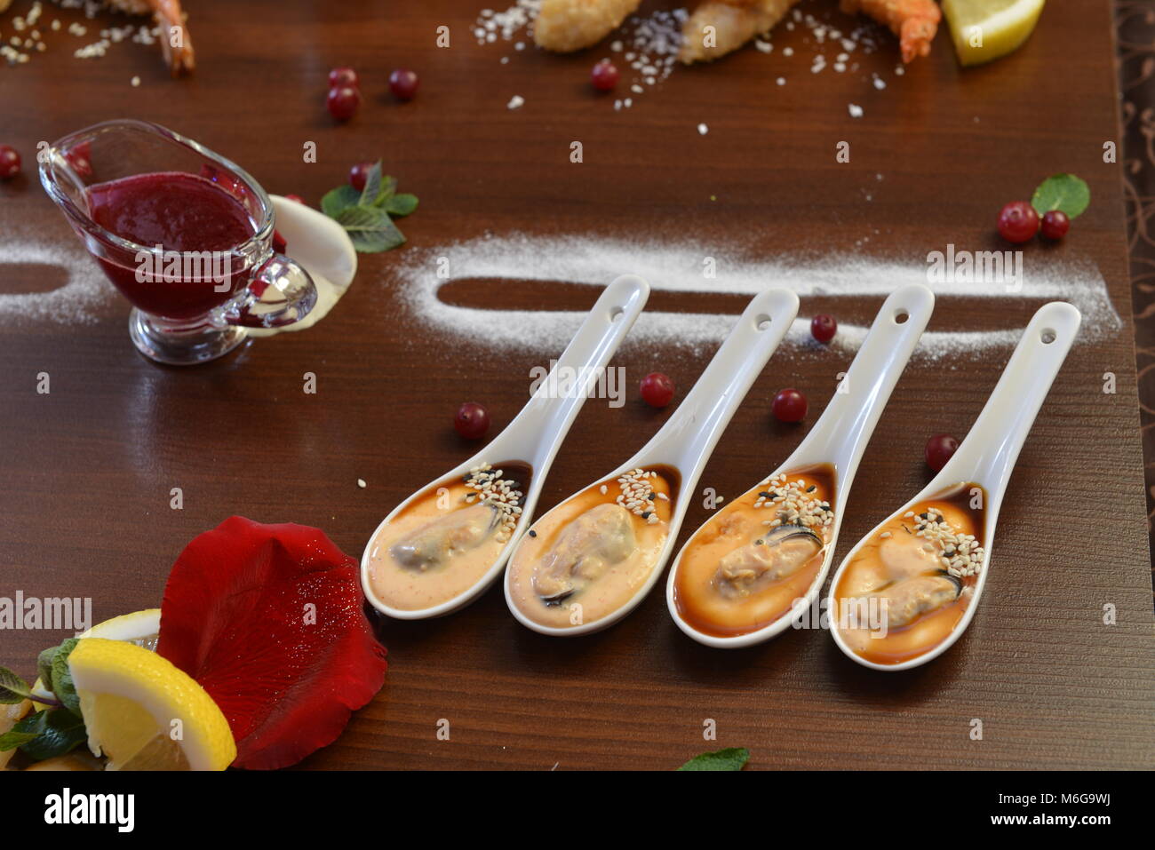 party appetizers. Four white spoons with mussels Spanish Tapas ...