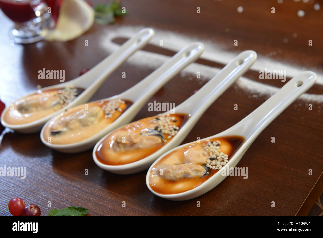 party appetizers. Four white spoons with mussels Spanish Tapas ...