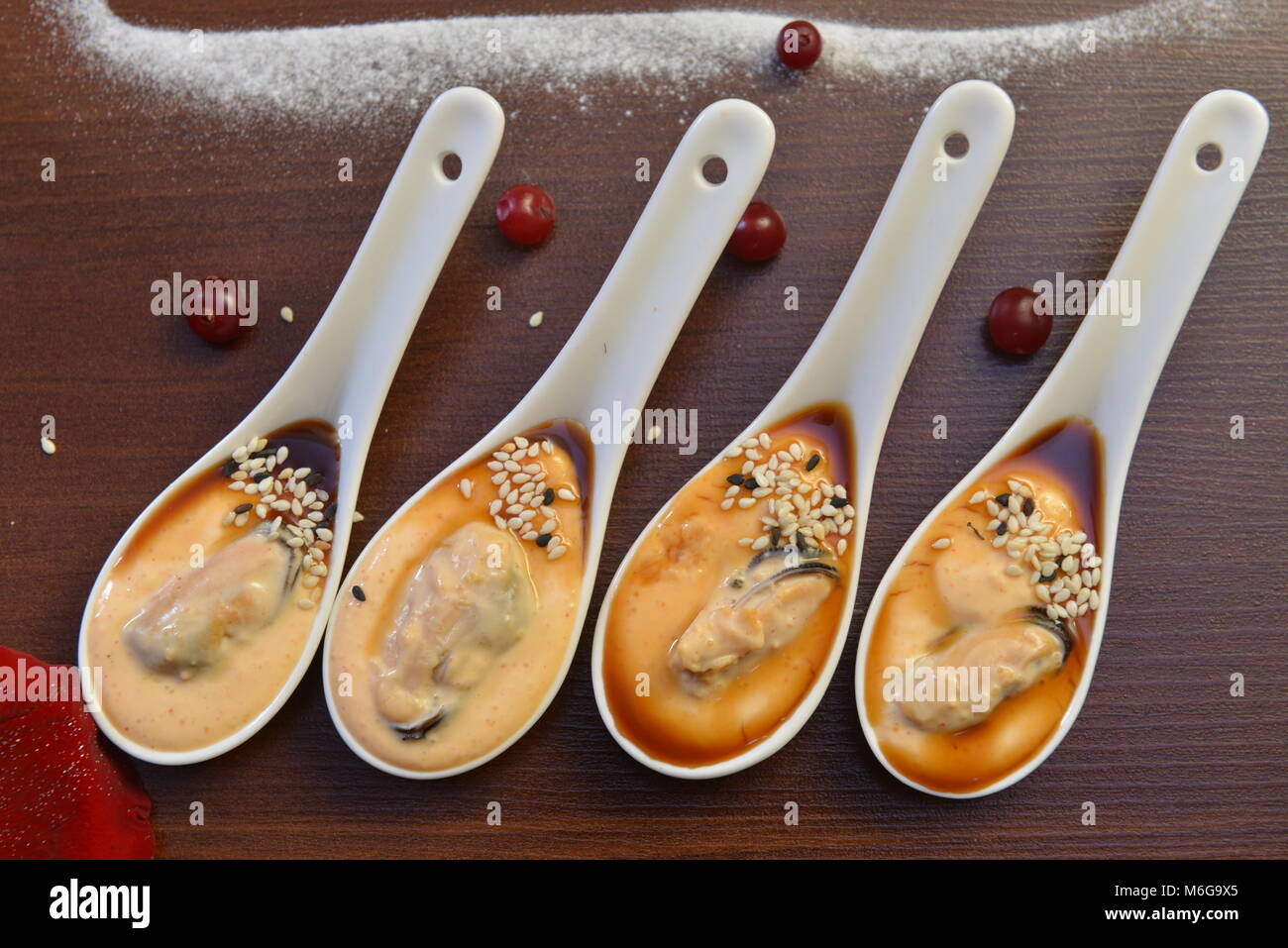 party appetizers. Four white spoons with mussels Spanish Tapas ...