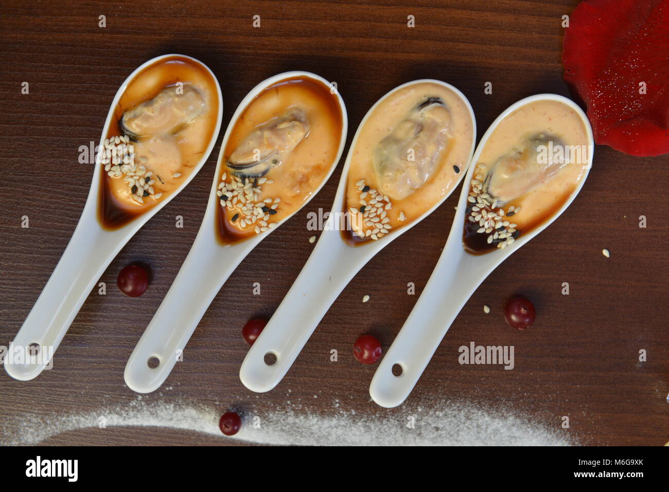 party appetizers. Four white spoons with mussels Spanish Tapas ...