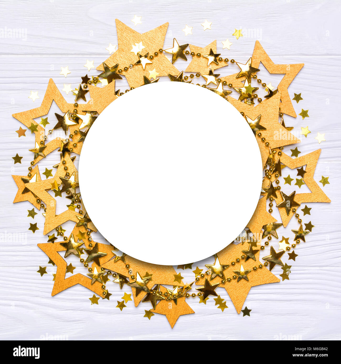 Flat lay empty round frame of big and small stars of confetti. Golden ...