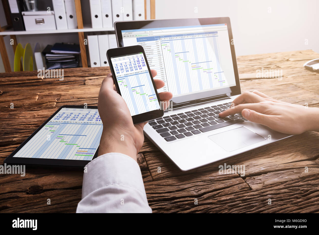 Close-up Of A Businessperson's Hand Using Smartphone While Analyzing ...