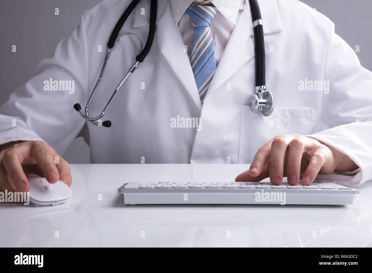 Close-up Of A Doctor's Hand Using Computer Keyboard On White Desk Stock ...
