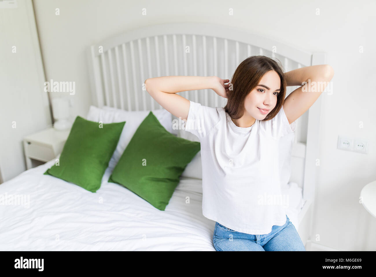 Beautiful young girl lying in bed. Young beautiful, woman waking up ...