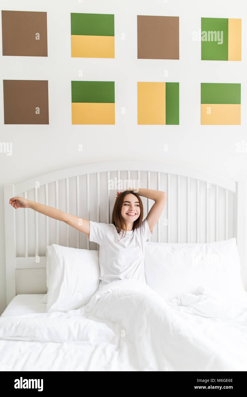 Beautiful young girl lying in bed. Young beautiful, woman waking up ...