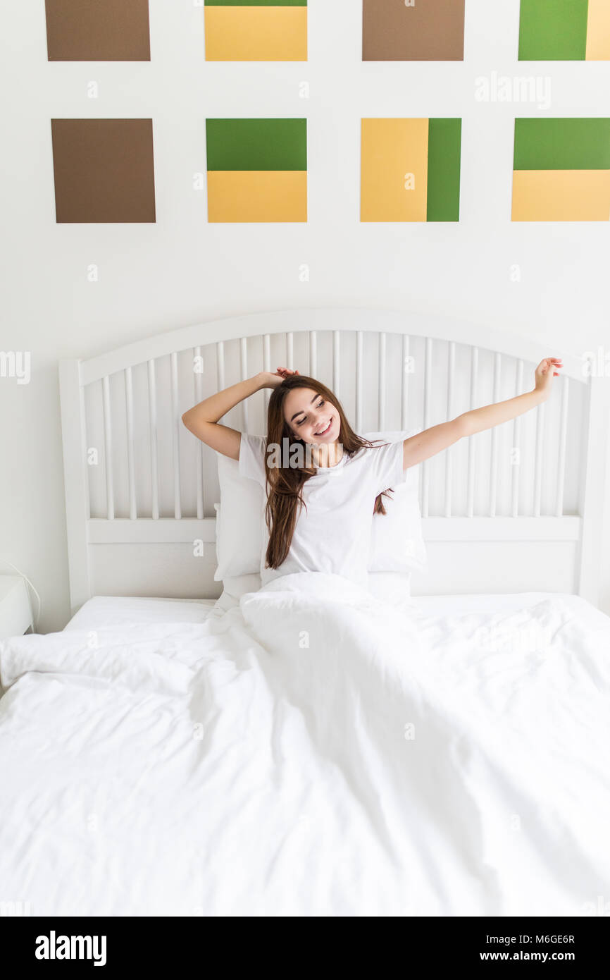 pretty happy girl waking up in the morning and stretching Stock Photo ...