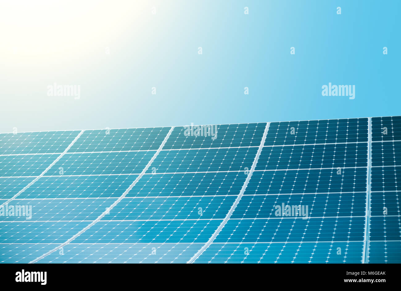 Photovoltaic modules of huge solar panels with sun and clear blue sky ...