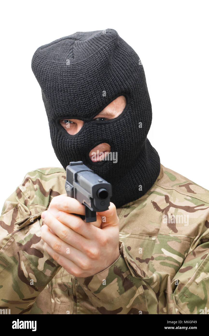 Crazy man in mask and camouflage uniform holding gun with two hands ...