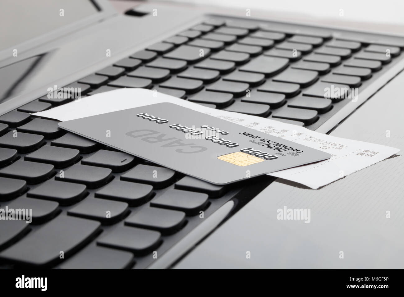 Close up studio shot of a credit card and receipt over computer ...