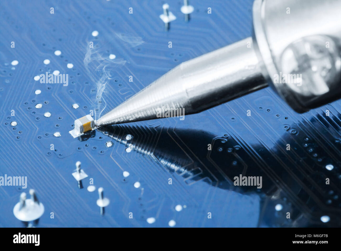 Electronic manufacturing and repair concept - soldering iron in a ...