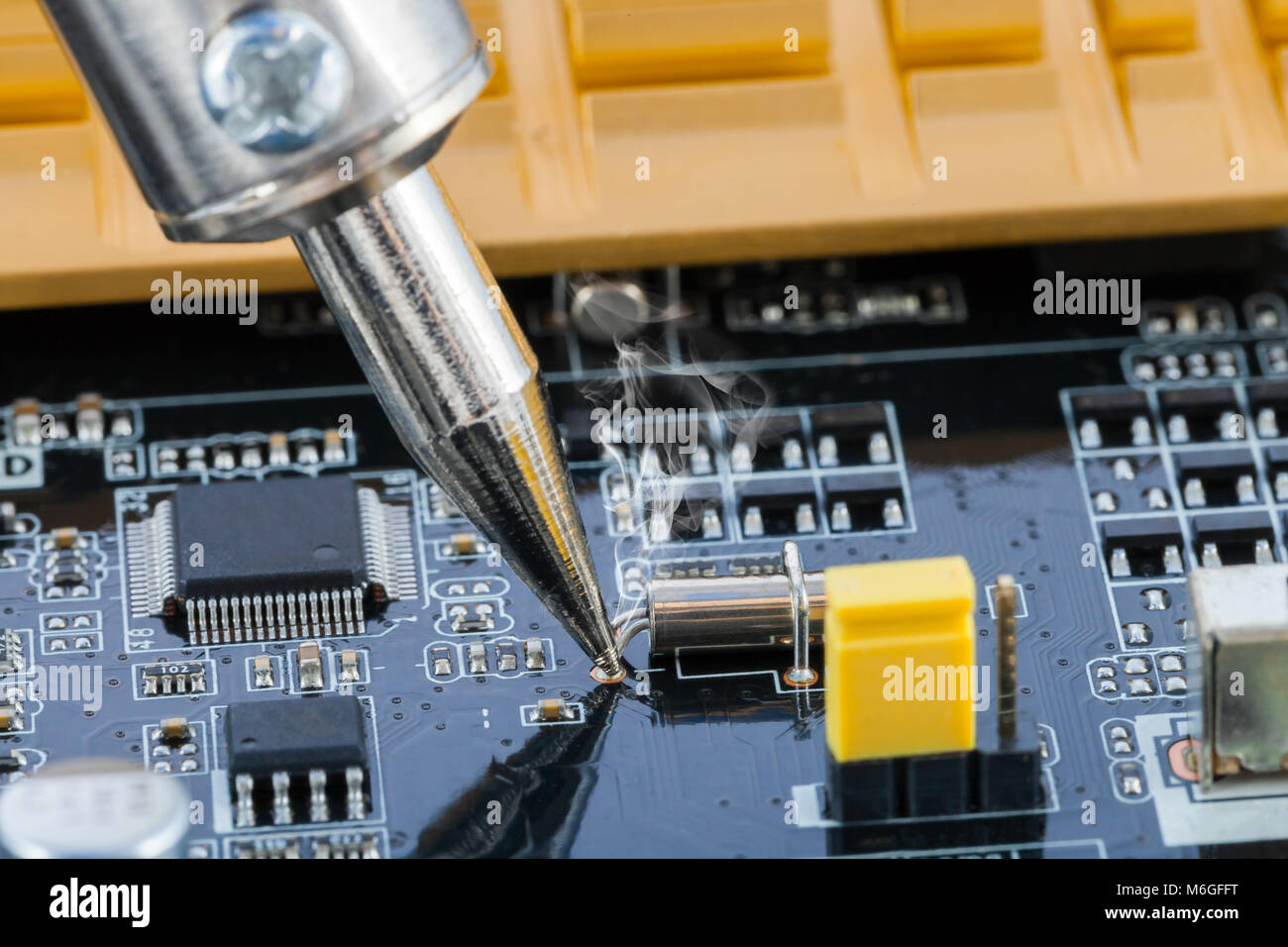 Soldering iron fixing microcircuit - close up studio shot Stock Photo ...