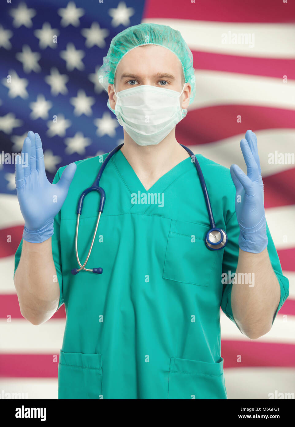 Surgeon holding his hands up with USA flag on background Stock Photo ...