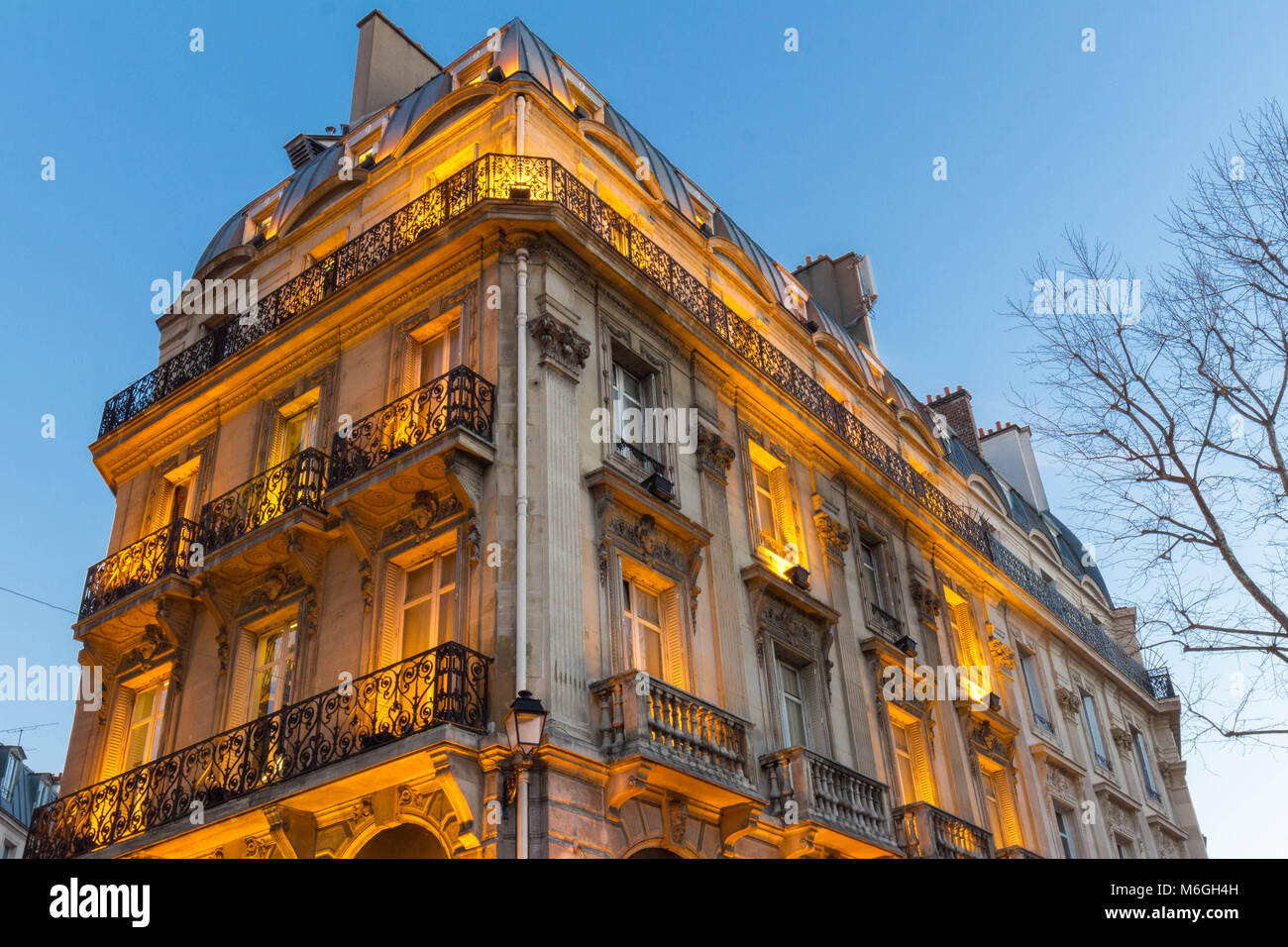 The traditional facade of Parisian building in the evening, France ...