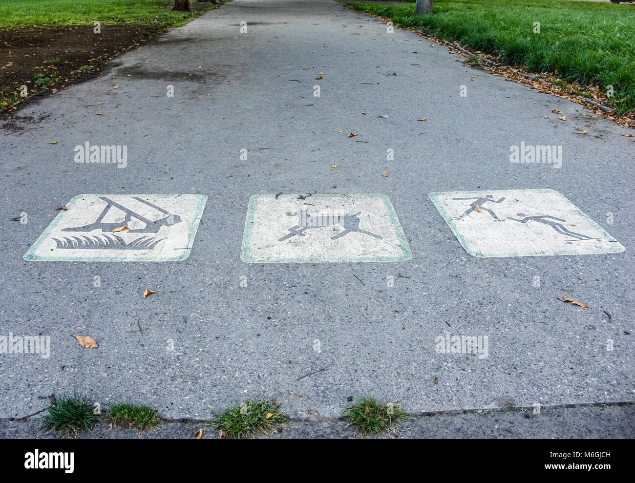 Informative signs provide guidelines for pedestrians on park pathway ...