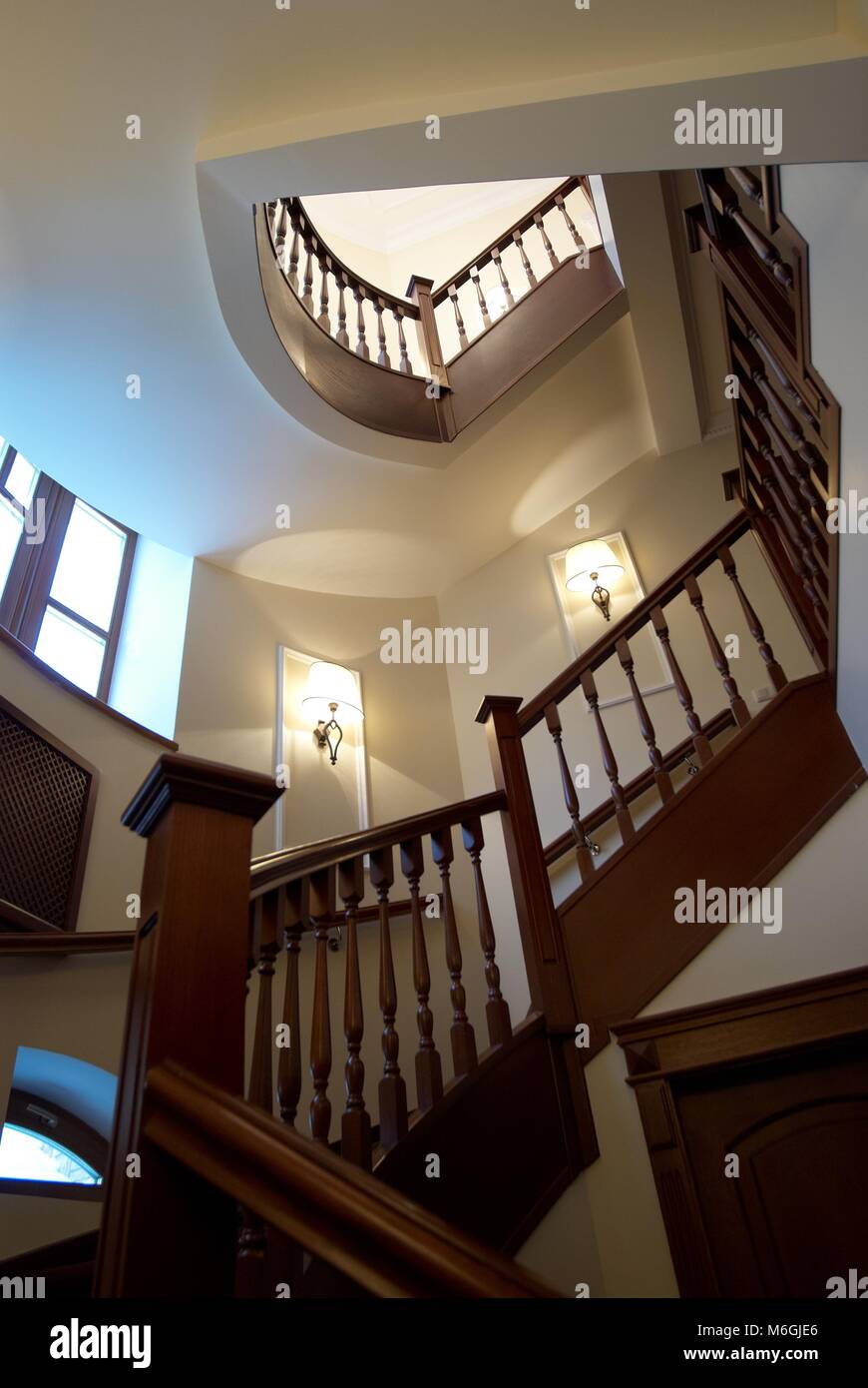 Spiral wooden staircase with balusters pillars and a massive handrail ...