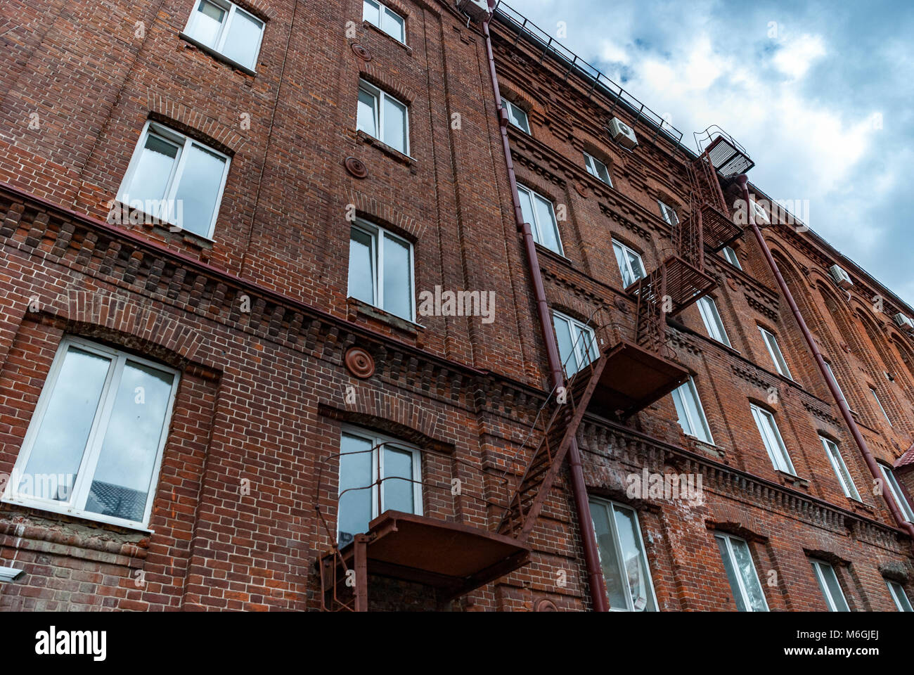 Metal fire escape ladder on the brick facade of a historic building ...