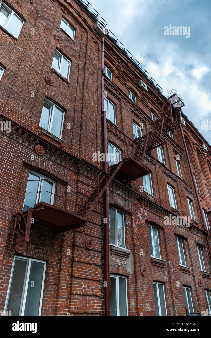 Metal fire escape ladder on the brick facade of a historic building ...