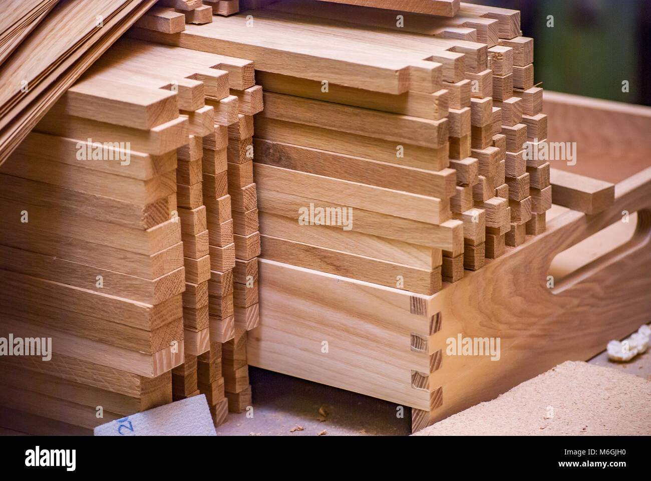 A finely milled box joint corner of a wooden drawer showcases expert ...
