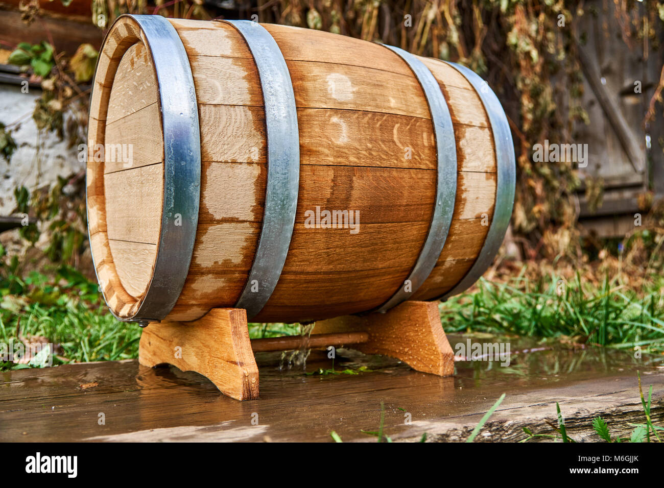 Old oak barrel for storing wine stands on a special stand during ...